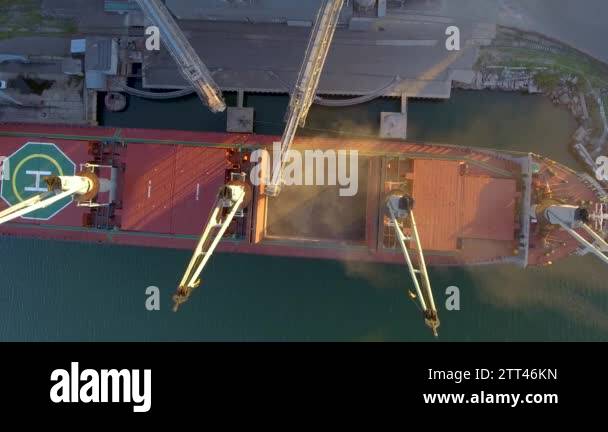 Close view of ship loading grain crops on bulk freighter via trunk to ...