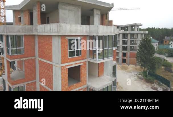 Flight above the construction site of the concrete frame of a multi-storey building. Concrete ...