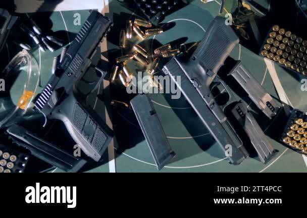 Guns, weapons with bullets on a shooting range, top view Stock Video ...