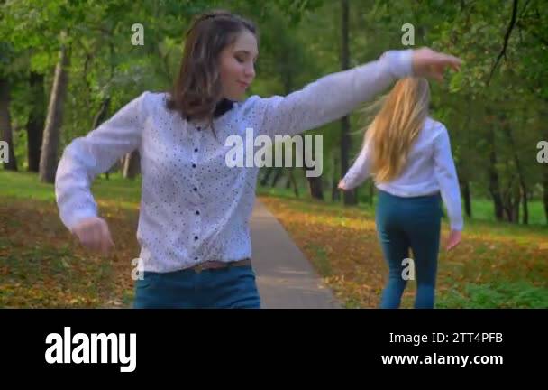 Two Funny Caucasian Girls Are Hanging Out Together, Jumping In ...