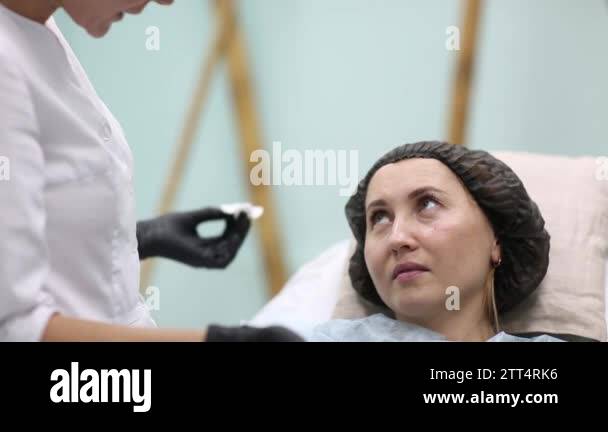 Cosmetologist doctor make facial beauty injections to her woman client ...