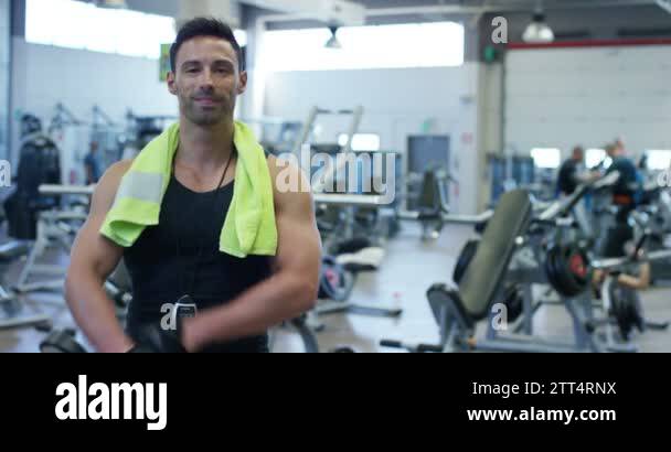 Guy bodybuilder in the gym, works with a barbell, bench press ...