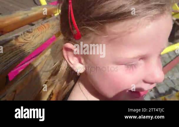 Cute small girl on funfair attraction. Funfair carousel. Close up of ...