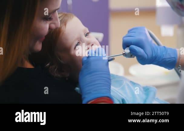 Dentistry. Female dentist examines the oral cavity of little baby Stock ...