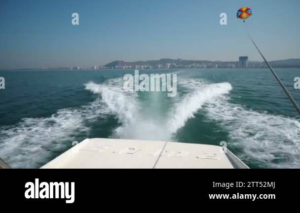 Parasailing water amusement. Flying on a parachute behind a boat on a ...