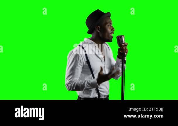 Man singer in half of the turnover sings into a microphone and dance ...