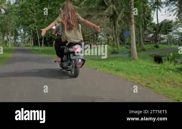 Couple riding their scooter through forest. life style idea concept ...