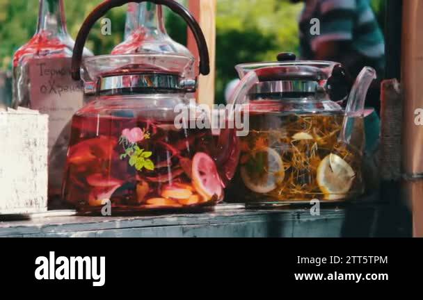 Stylish transparent beautiful teapot with herbal infusion and lemon ...