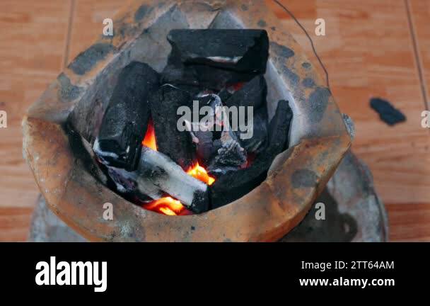 Burning charcoal in stove for preparing traditional food of Thailand ...