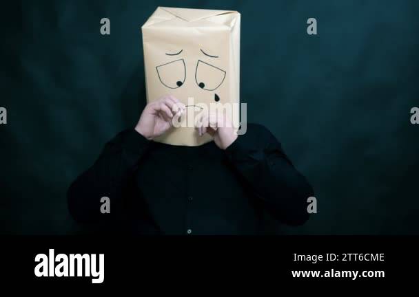 The concept of emotions. A man wipes tears on his face. On the face of ...