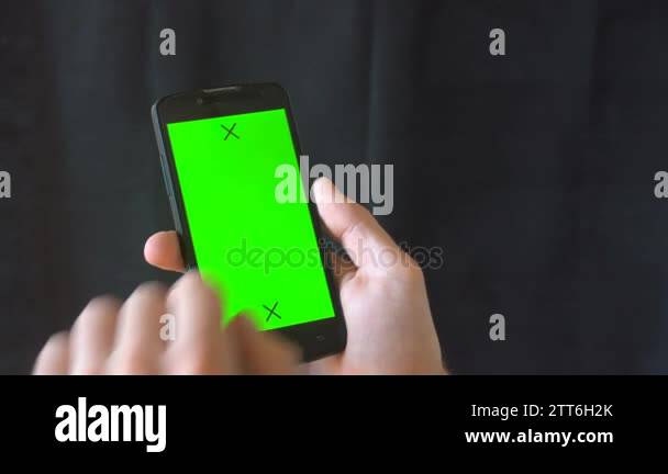 Close-up of male hands touching of smartphone. Green screen Chroma Key ...
