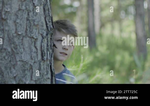 Boy behind tree Stock Videos & Footage - HD and 4K Video Clips - Alamy