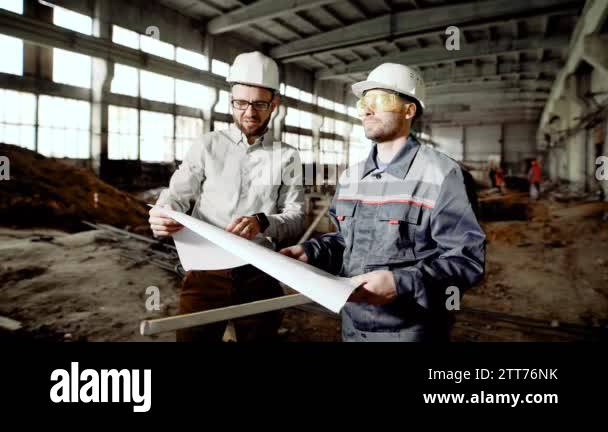 Foreman and chief engineer at the construction site of the factory. The ...