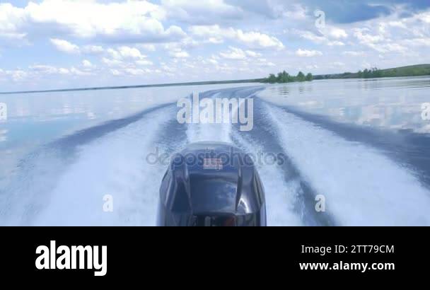 Trail on water surface behind of fast moving motor boat. the motor of ...