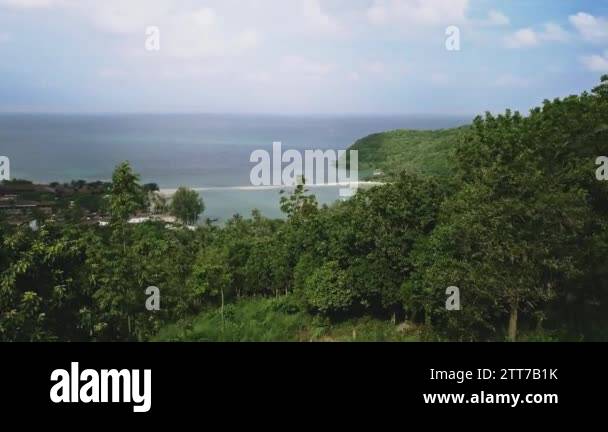 flying over a tropical island. two islands are connected by a sand bar ...