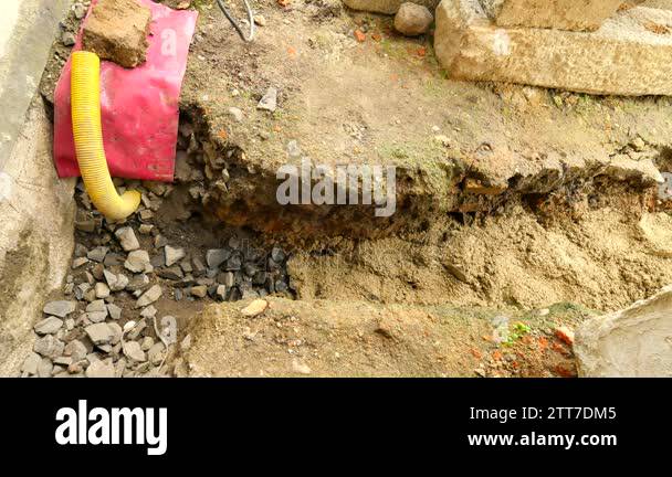 Pouring, laying concrete into foundations of the house using shovel of ...