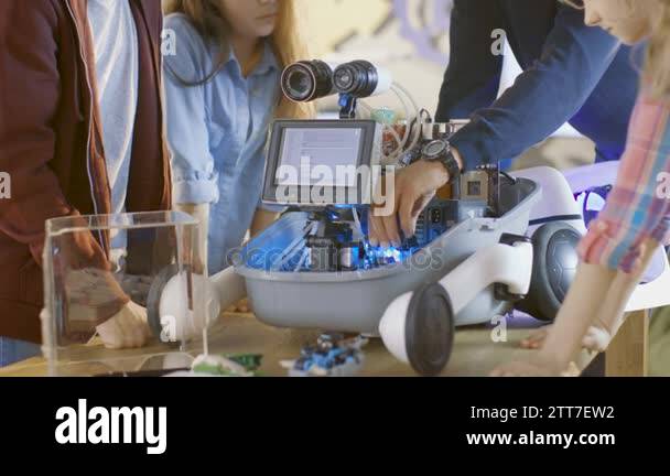 Teacher and His Pupils Work on a Programable Robot with LED ...