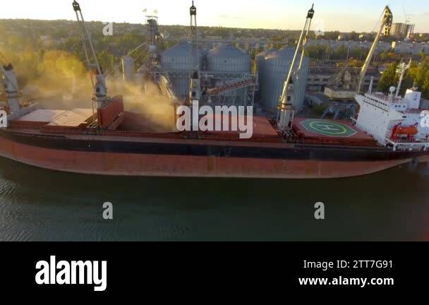 Close view of ship loading grain crops on bulk freighter via trunk to ...
