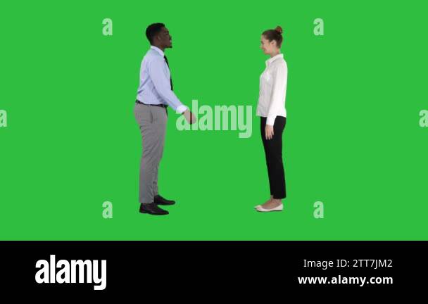 African man and caucasian woman giving low five on a Green Screen ...