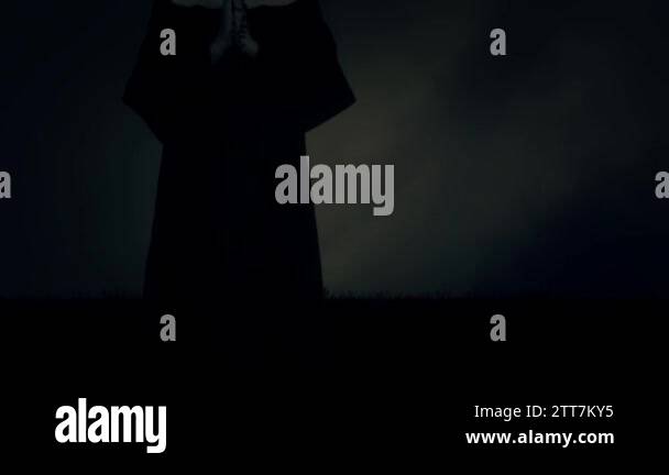 Nun Wearing Veil Standing in a Praying Pose Under Rain and Lightning ...