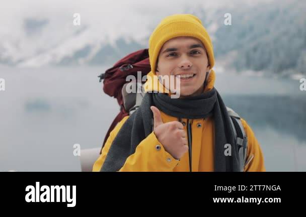 Portrait of a young hiking man with backpack standing standing on ...