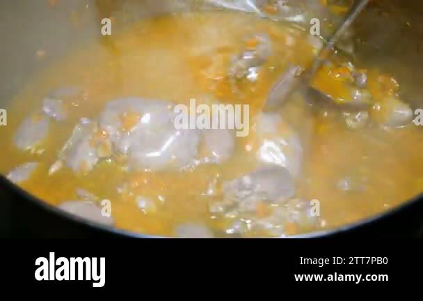 Cooking homemade food. Goulash or thick soup of chicken giblets with ...