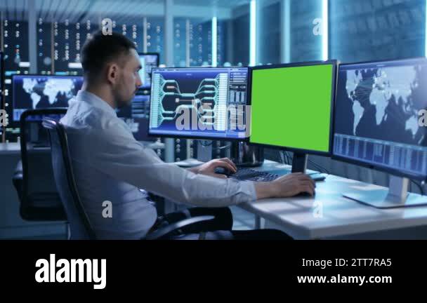 Technical Controller/ Operator Working at His Workstation with Multiple ...