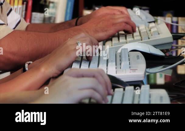 Students use a set of computers in the library Stock Video Footage - Alamy