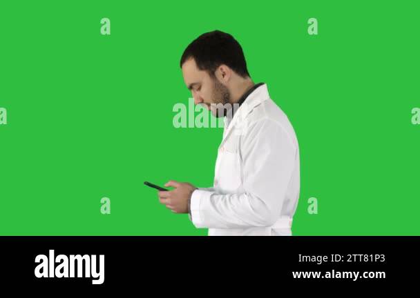 Medium shot side view. Man doctor walking and looking attentively at ...