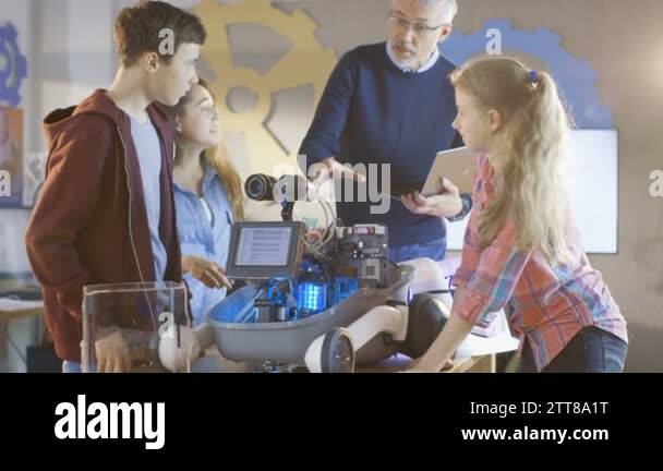 Teacher and His Pupils Work on a Programable Robot with LED ...