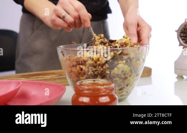 Woman adding honey to a nut butter and mixing ingredients in bowl Stock ...