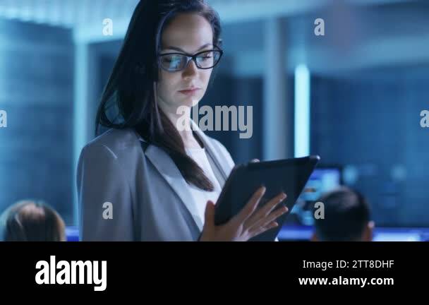 Young Female Government Employee Wearing Glasses Uses Tablet in System ...