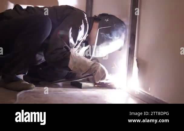 Welder Worker Performs Jump Welding. Worker Welder Performs Arc-Welding ...