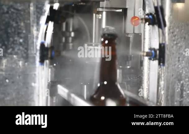 Empty bottles going through technological washing line in a beer factory. Technological line for ...