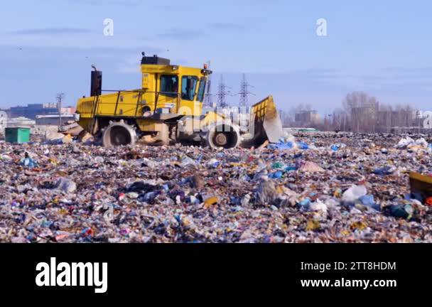 Waste, garbage, dump, rubbish 4K. A landfill compactor working at a ...