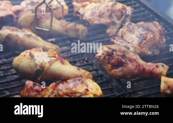 Chicken meat that turn over on a barbecue grill.Meat is fried in Mangal ...