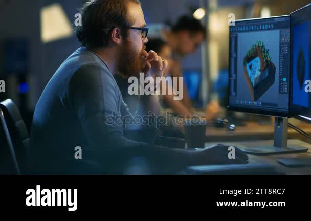 Male Game Developer works on a Level Design on His Personal Computer ...