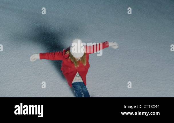 Top Down Footage of the Happy Cute Little Girl Falling into Snow, Lying ...