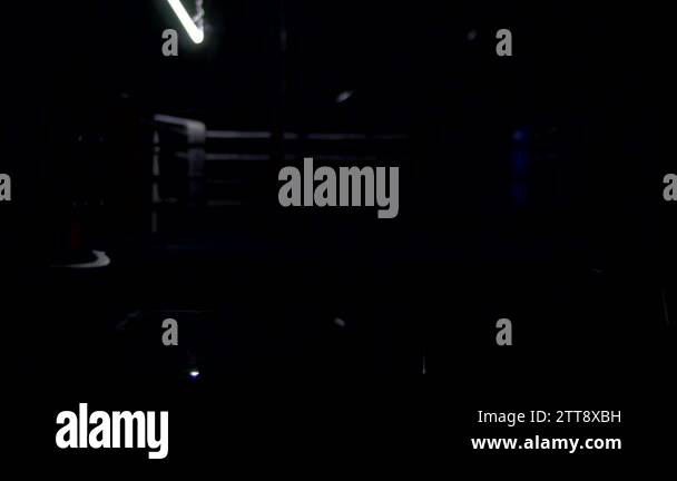 Boxing ring and two chairs with table dark background. View of a ...