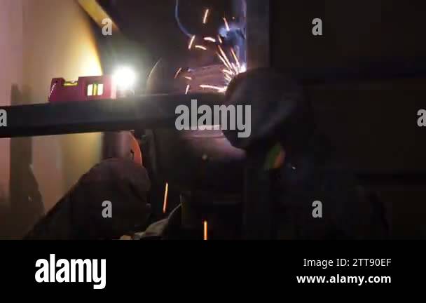 Welder Worker Performs Jump Welding. Worker Welder Performs Arc-Welding ...