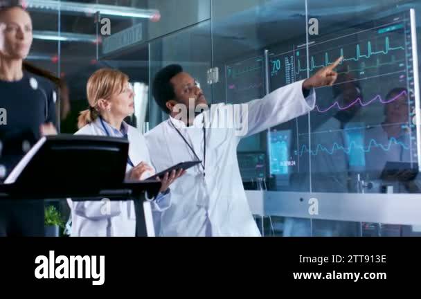 Woman Athlete Runs on a Treadmill with Electrodes Attached to Her Body ...