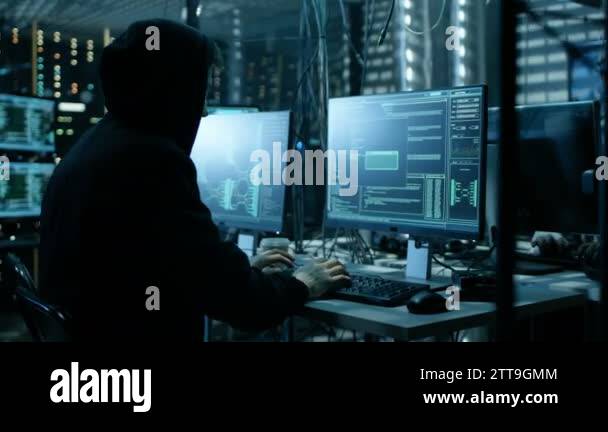 Hooded Hacker and His Group Break into Corporate Data Servers. Place Has Dark Atmosphere ...