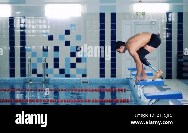 Disabled swimmer jumps into a training pool, side view Stock Video ...