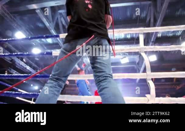 Winner declaration on boxing ring, downward motion view from behind of ...