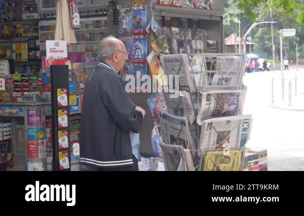 An Old Men Picking A New Paper From A Street Shop Stock Video Footage ...