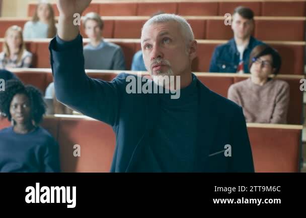 Camera Facing Class: Prominent Professor Writing on the Blackboard and ...