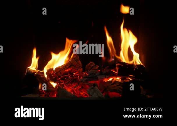 Burning spurts of flame turning wooden balks into grey ash in a ...