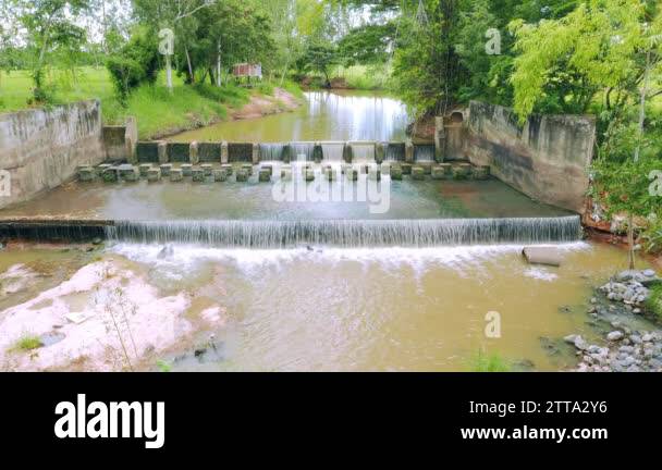Continuous water movement scene of weir or dam to slow down the flow of ...