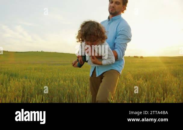 Father raising up his son to the sky, pretending he is flying. Father ...