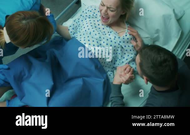 In the Hospital Woman in Labor Pushes to Give Birth, Obstetricians ...